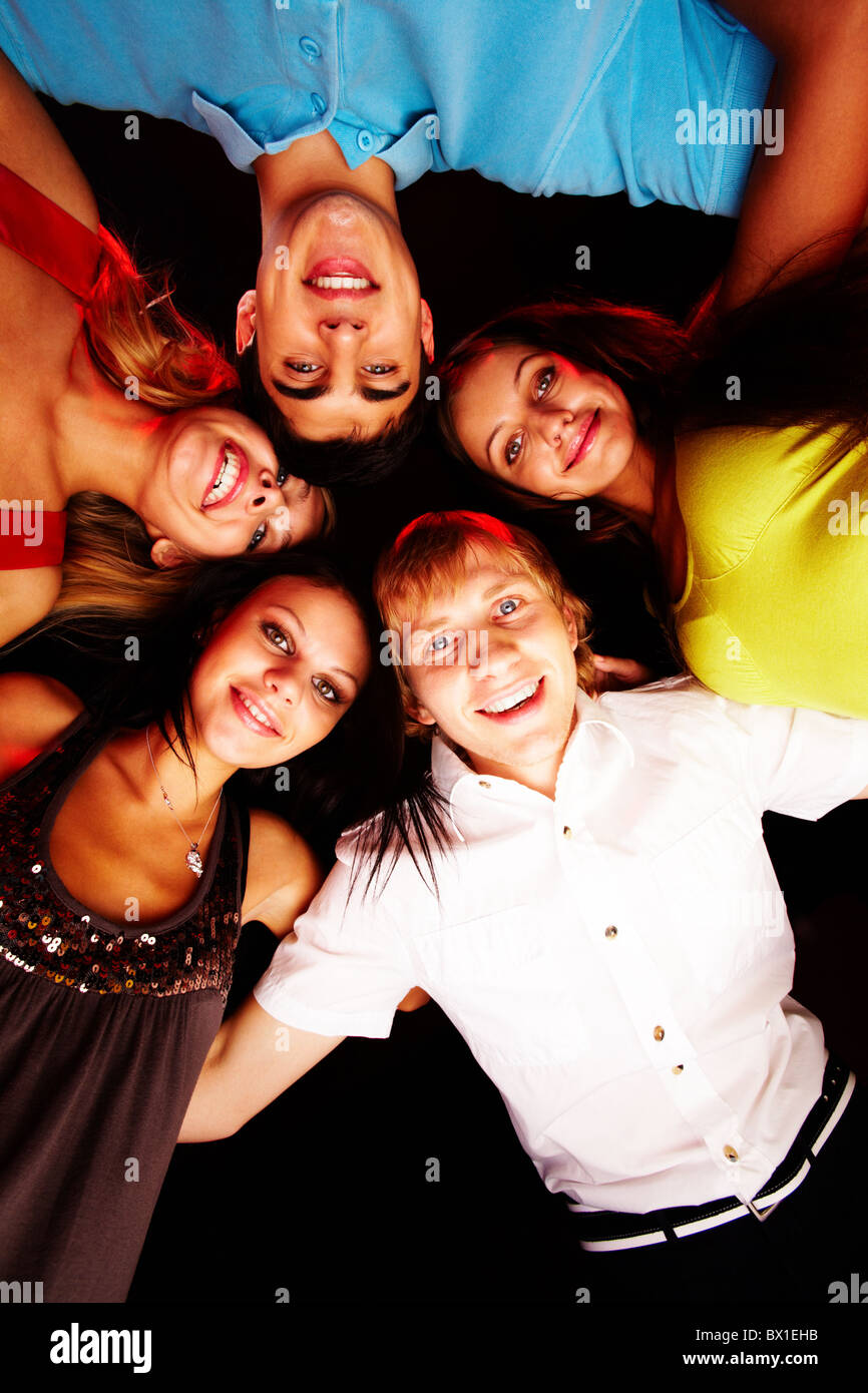 Below angle of group of friends embracing each other Stock Photo - Alamy