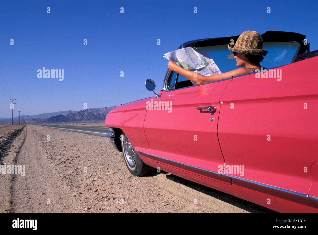 California Girl woman 1962 Pink Cadillac Convertible reading map Mojave ...