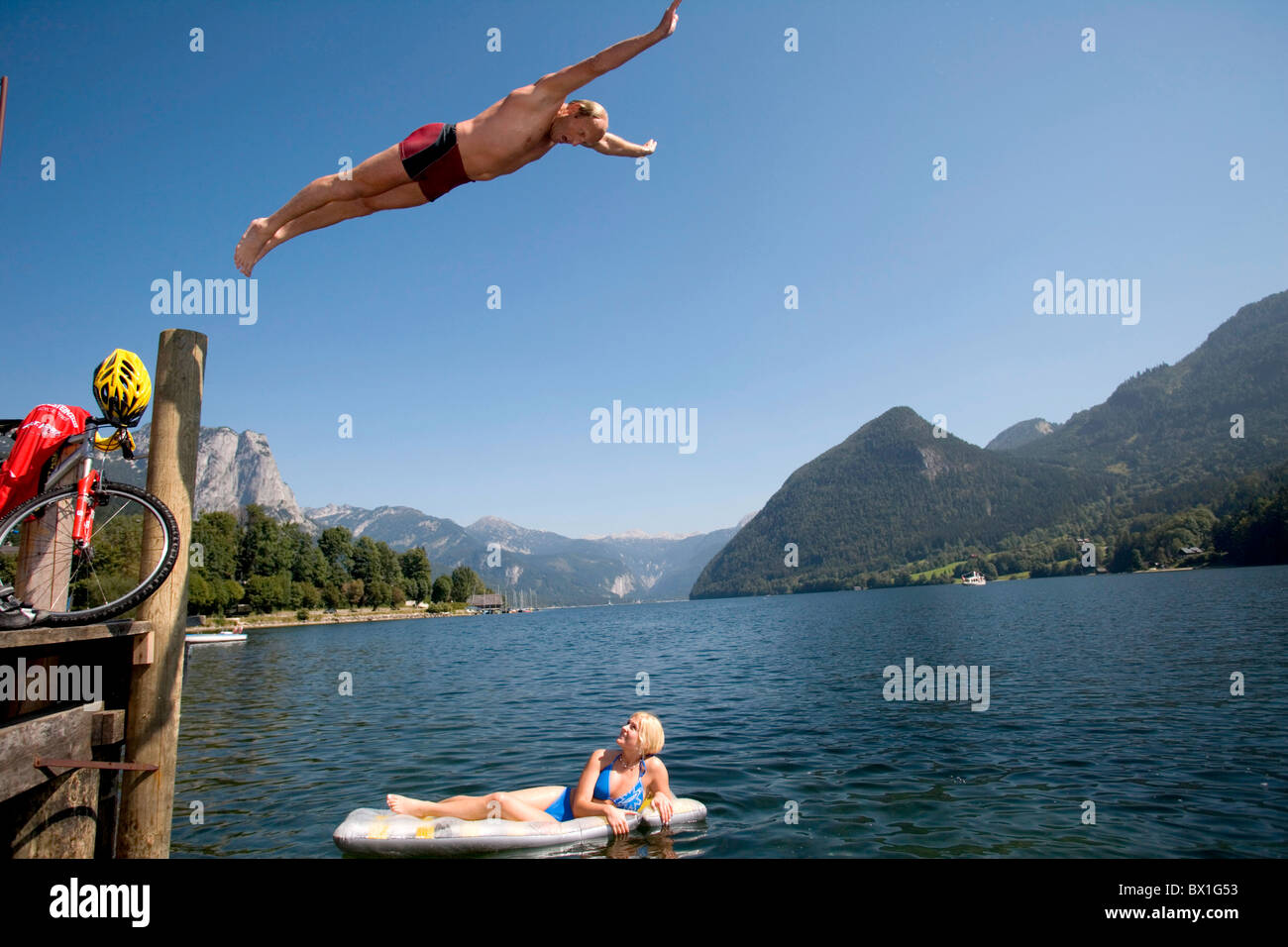 Couple dive jump water lake refreshment bathing lake bathing bicycle ...