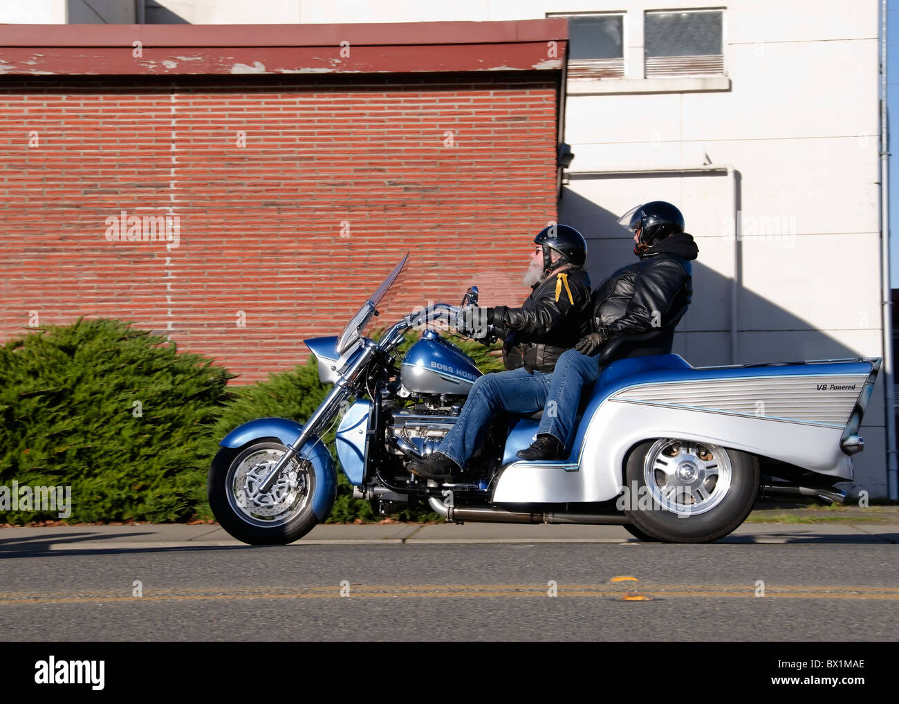 Two riders on a unique motorcycle participate in the 2010 Olympia Toy ...