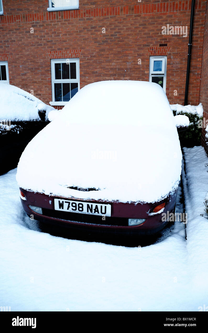 heavy snow covering ford focus car and road outside flats Stock Photo ...