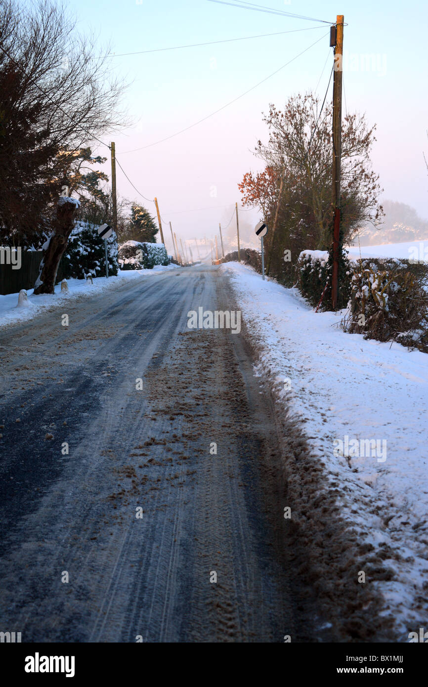 Snow covered verges and road looking out of the village towards North Downs, Lees Road ...