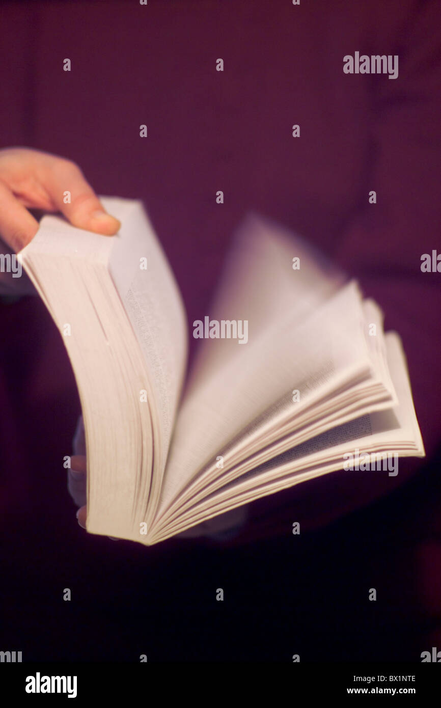 Book reading to sheets leaves paging through person hands searches ...