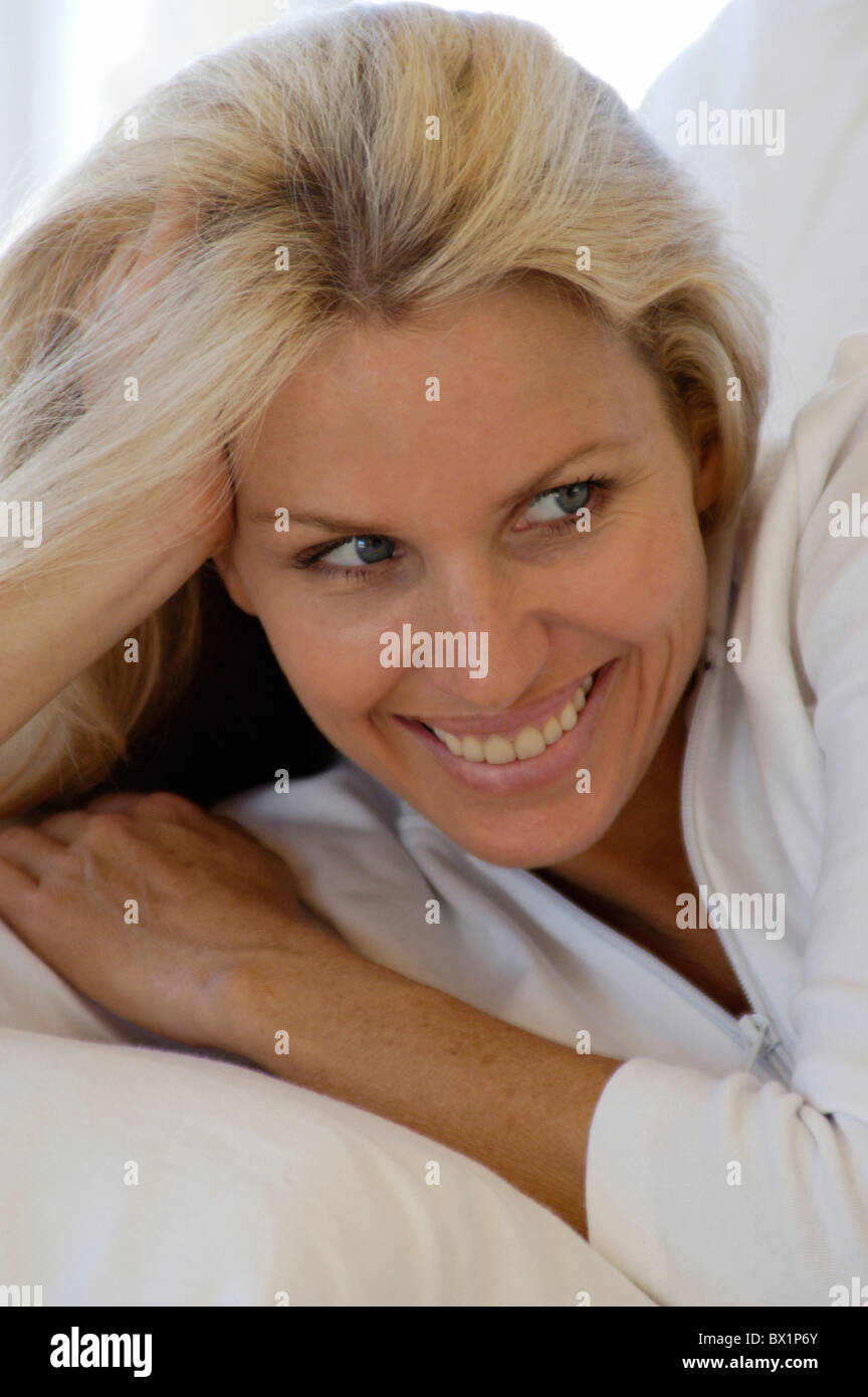 at home blond inside white Laughing lie portraits relax Woman Stock ...