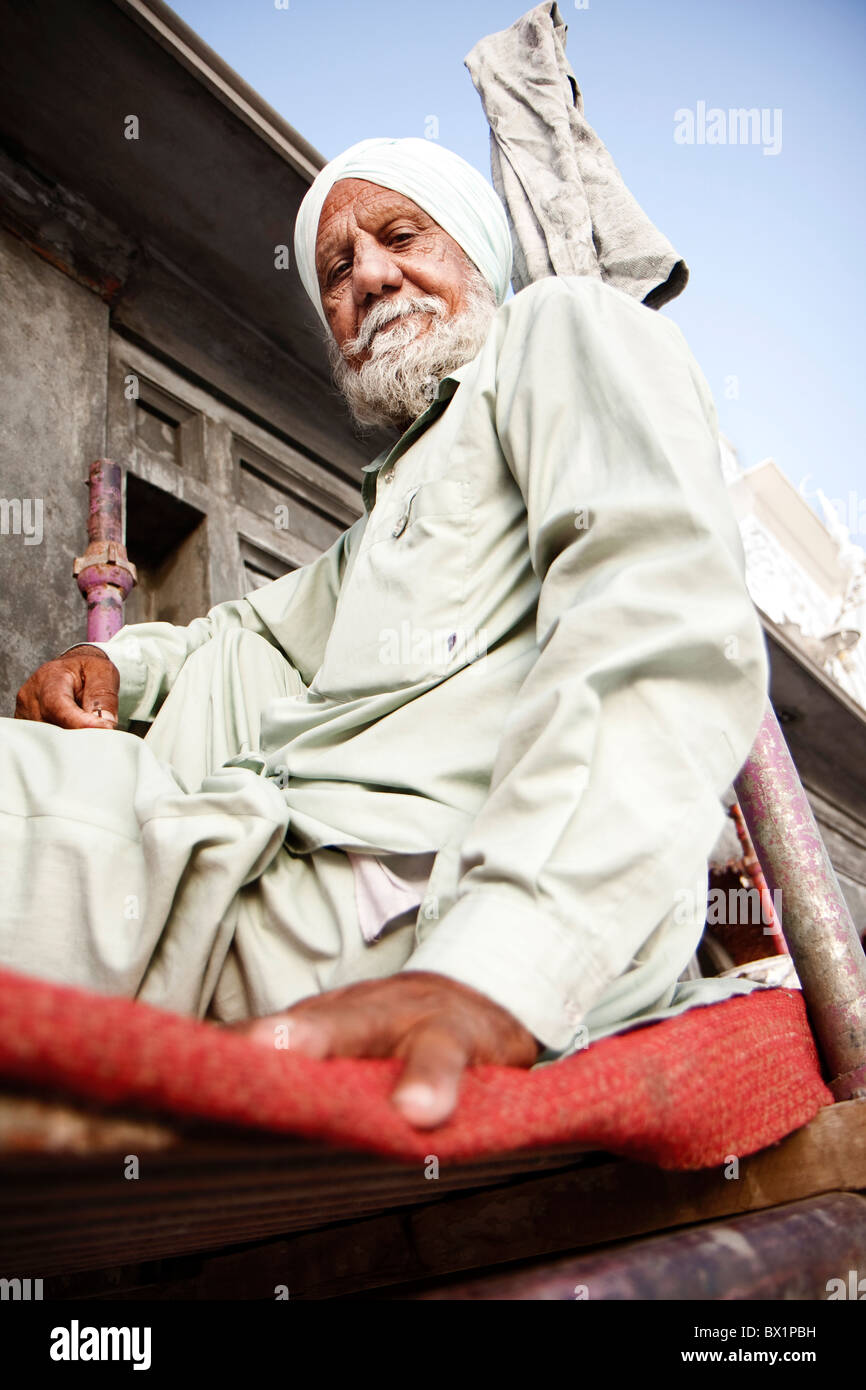 a Sikh sitting down, resting during work, Golden Temple, Amritsar ...