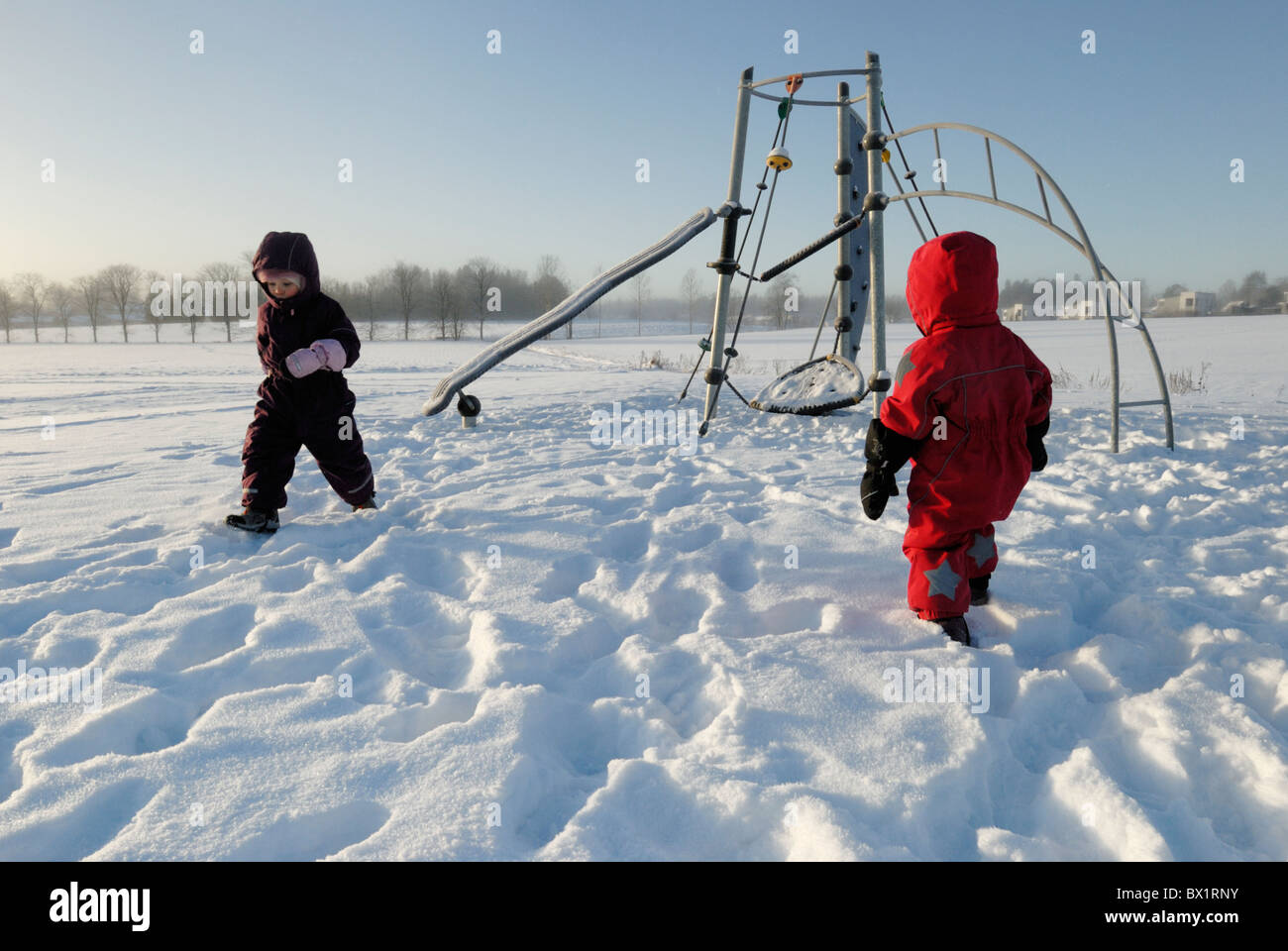 Children playing in the playground in winter Stock Photo - Alamy