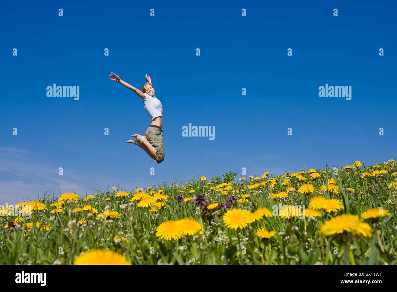 young female having fun on flowery meadow Stock Photo - Alamy