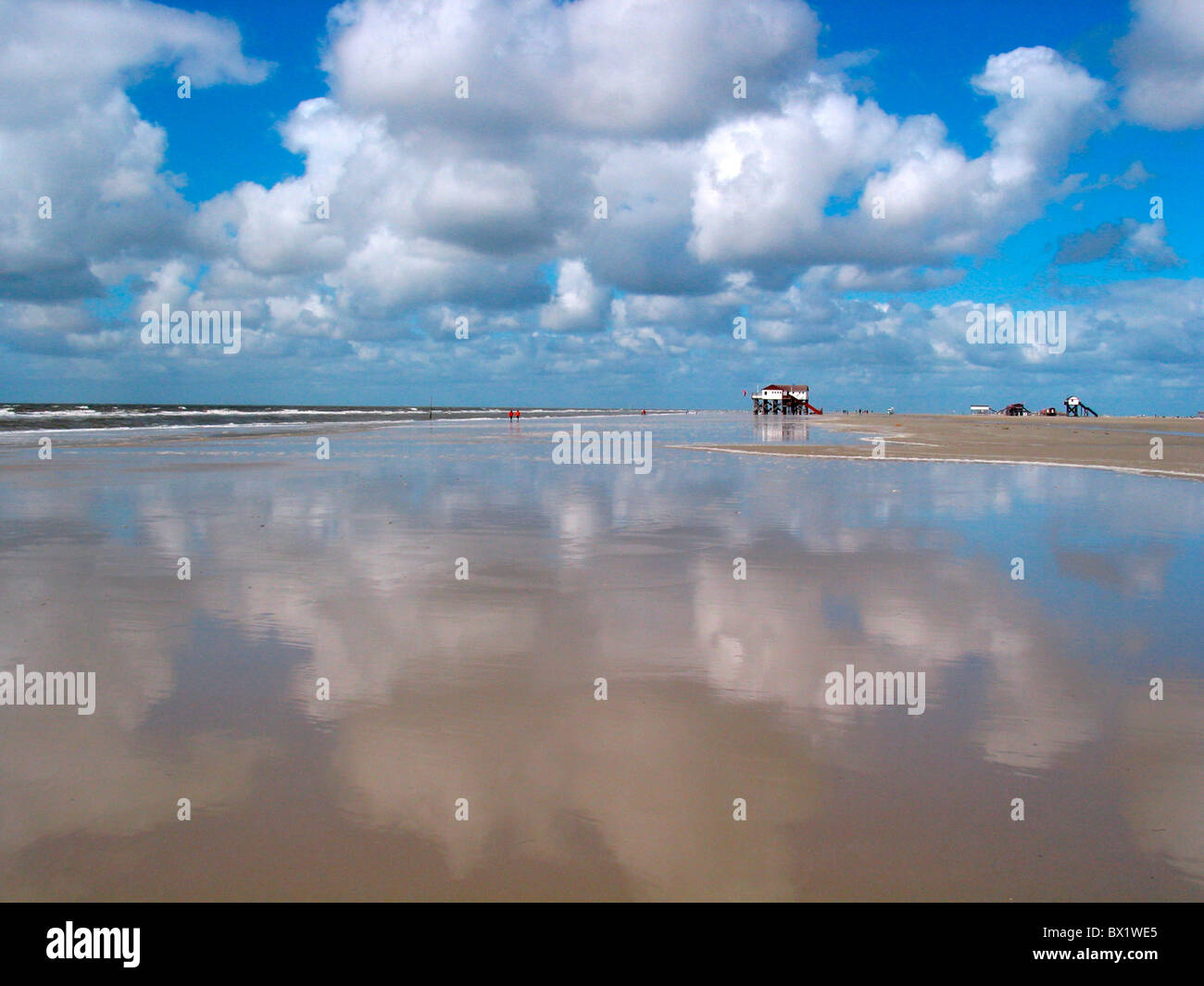 beach building on stilts clouds coast ebb tide flood Germany Europe ...
