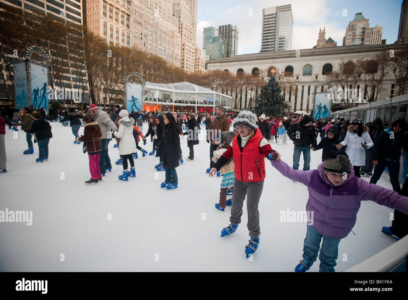 Skaters maneuver the packed Pond at Bryant Park ice skating rink in New ...