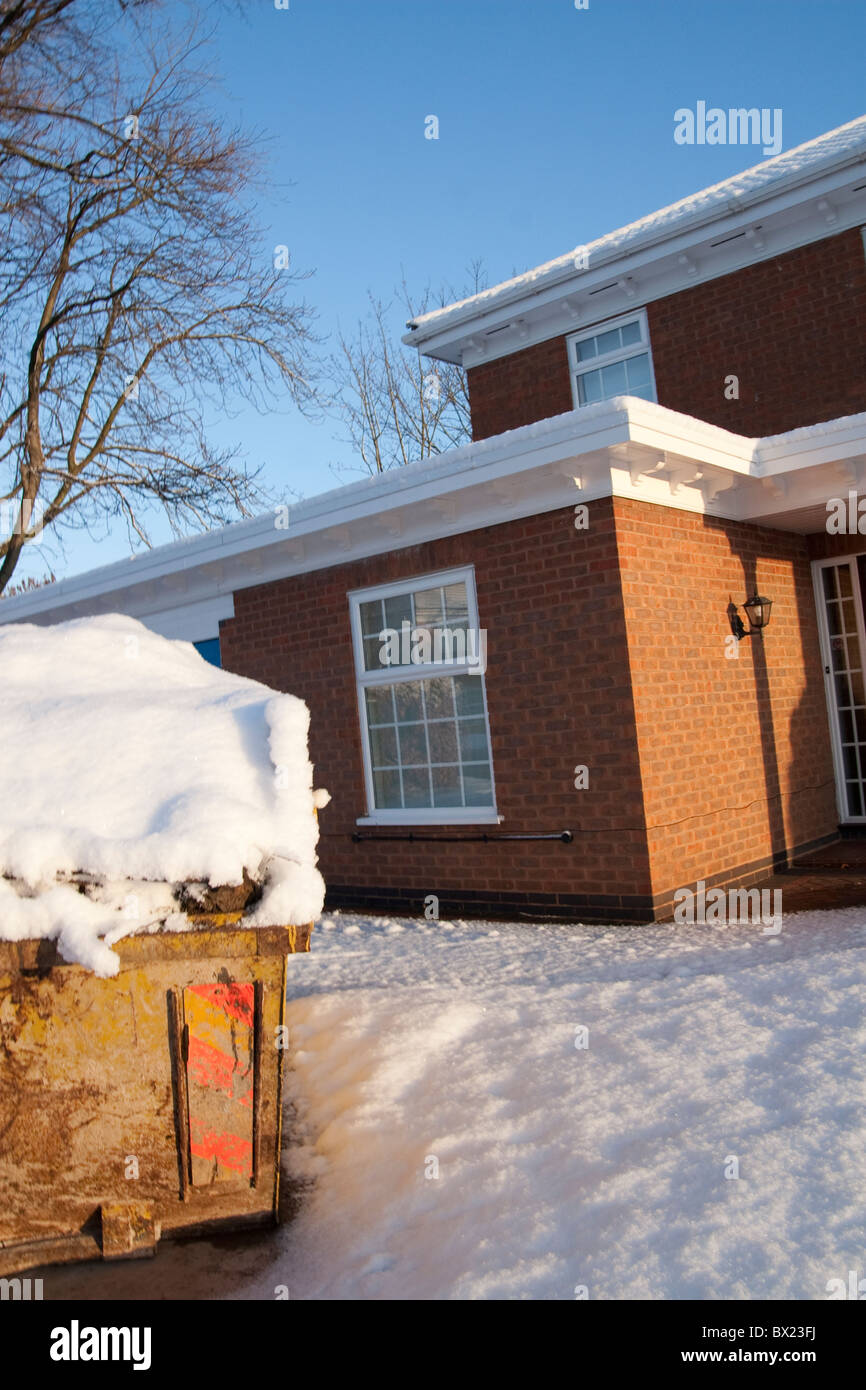 A skip full of snow outside a house in Nottingham England uk Stock ...