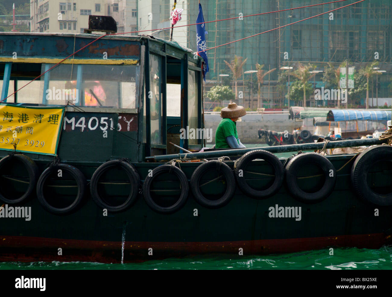 A traditional sampan boat cruises through the protected waters of ...