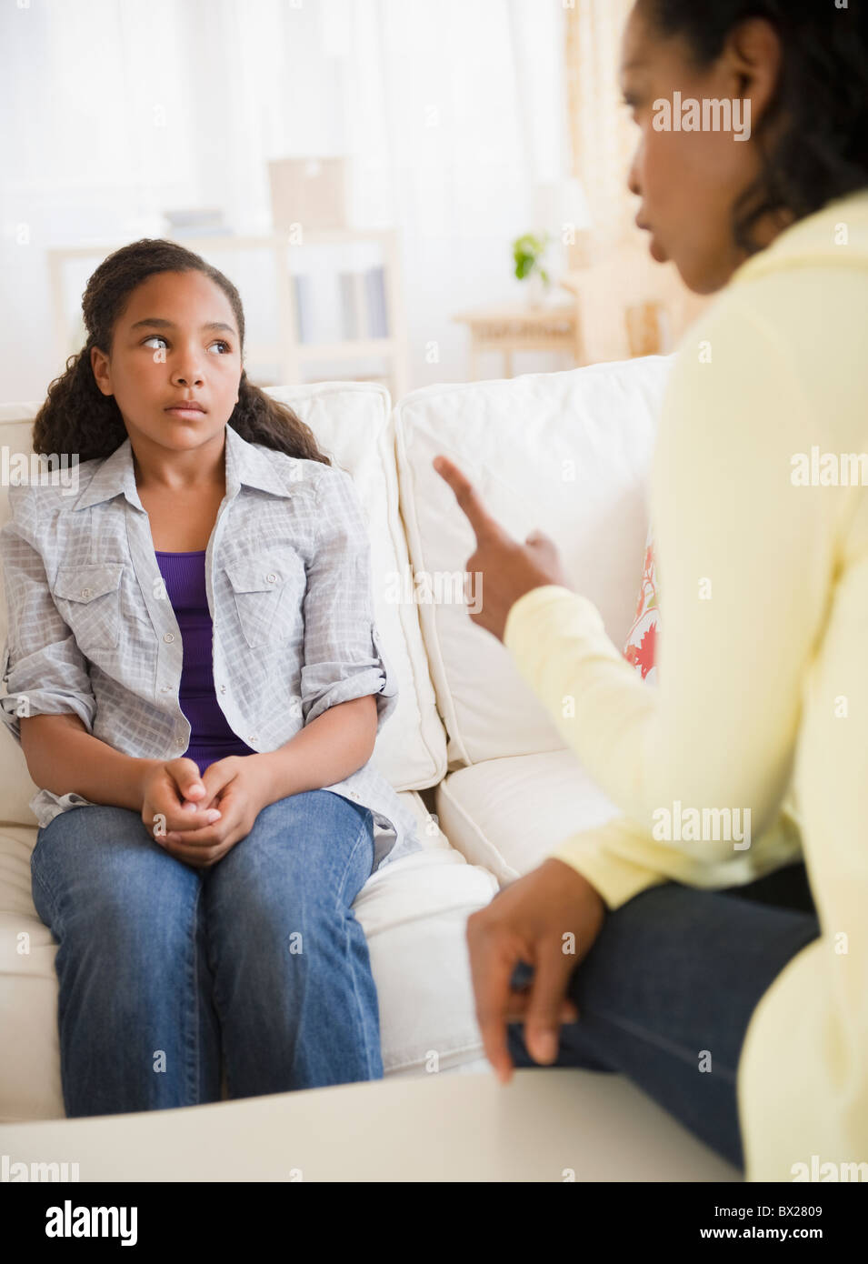 Mother lecturing daughter in living room Stock Photo - Alamy