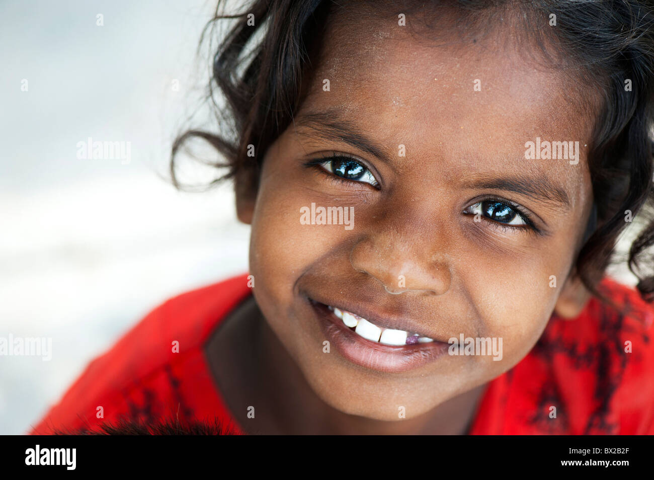 Smiling happy Indian village girl, to side of frame. Andhra Pradesh ...