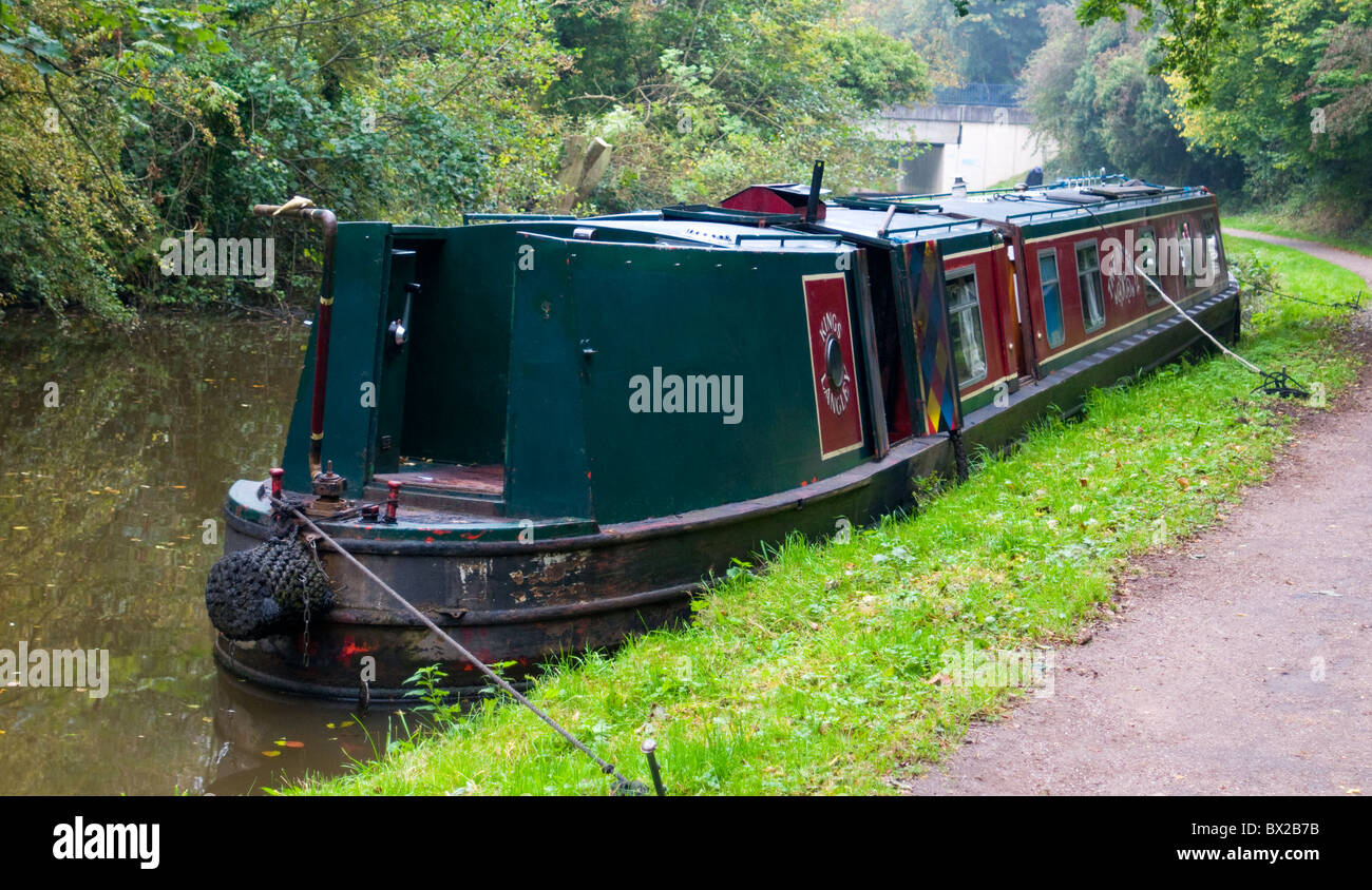 green barge canal boat moored alongside towpath Stock Photo - Alamy