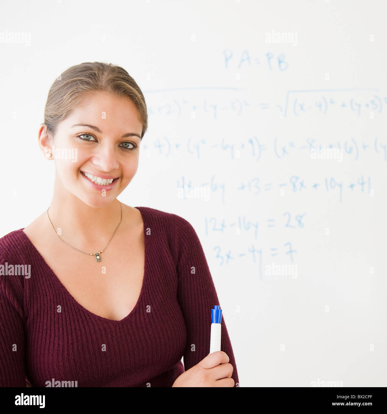Smiling Indian student next to whiteboard in classroom Stock Photo - Alamy