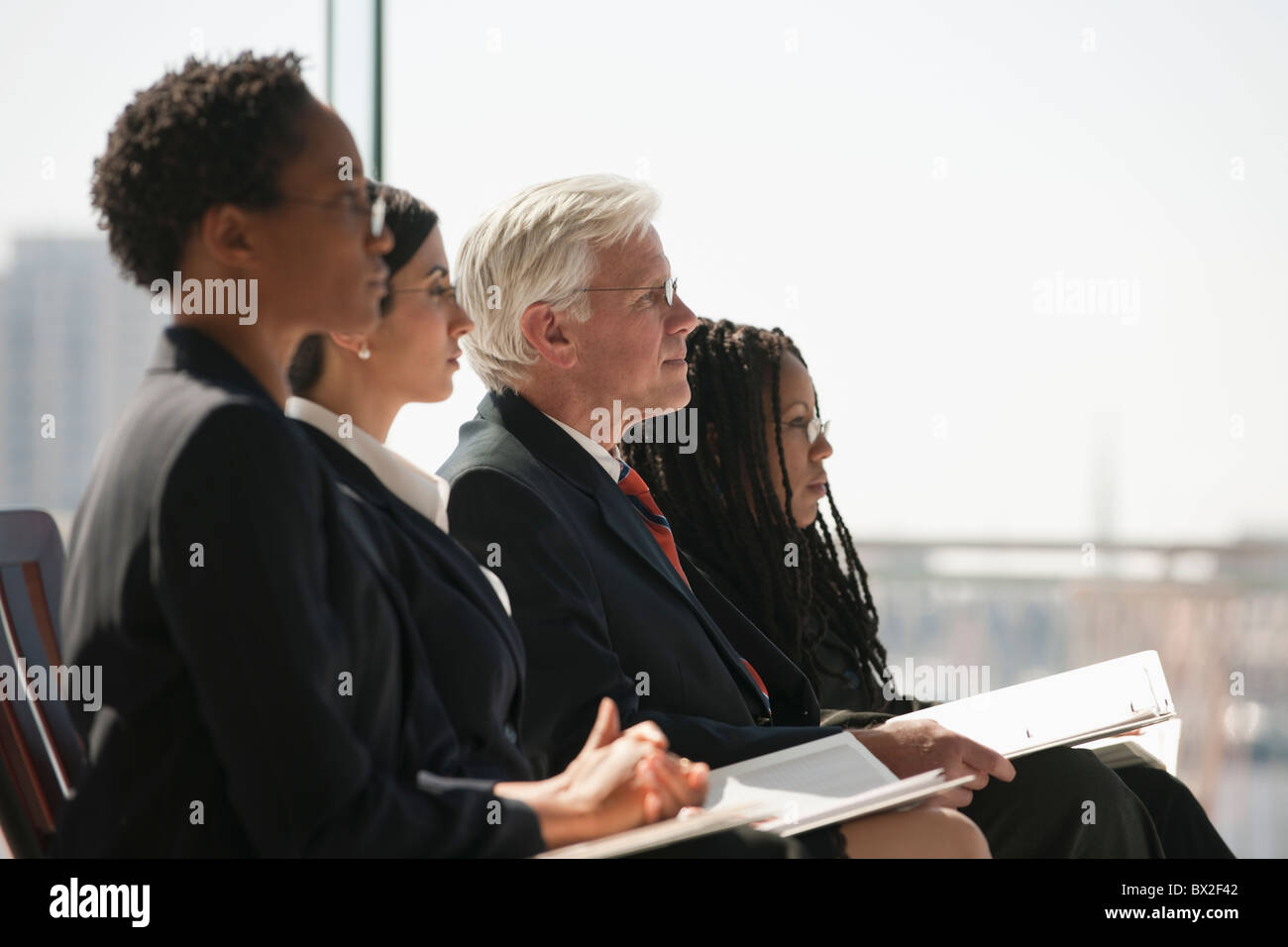 Serious business people listening in meeting Stock Photo - Alamy