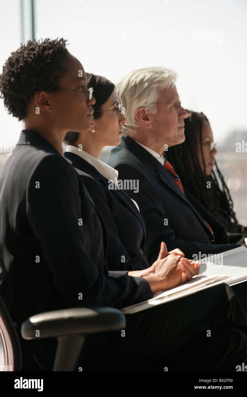 Serious business people listening in meeting Stock Photo - Alamy