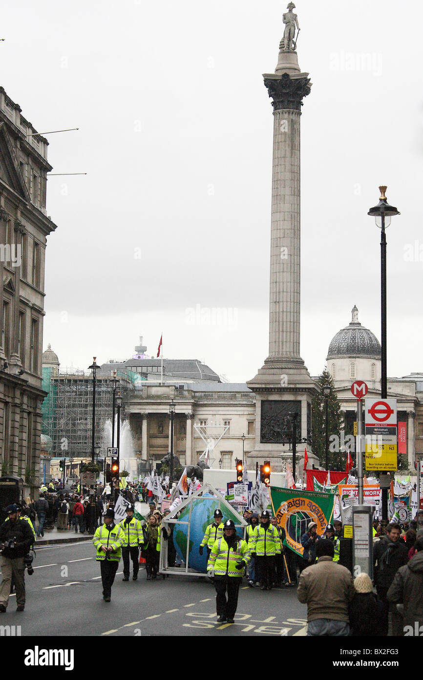Climate change protesters march past nelson's column Stock Photo - Alamy