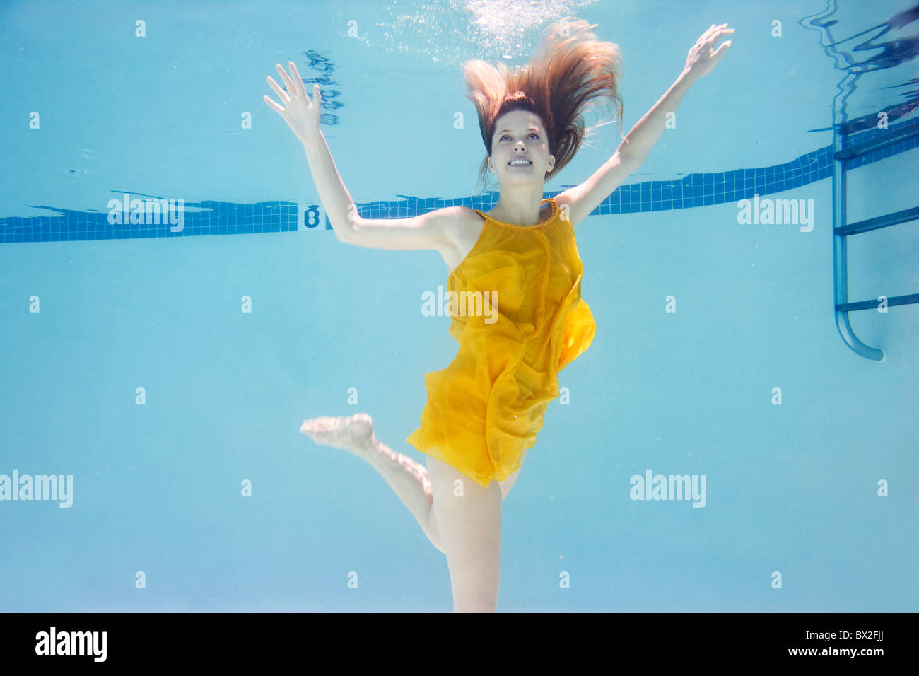 Caucasian woman in dress floating underwater Stock Photo - Alamy