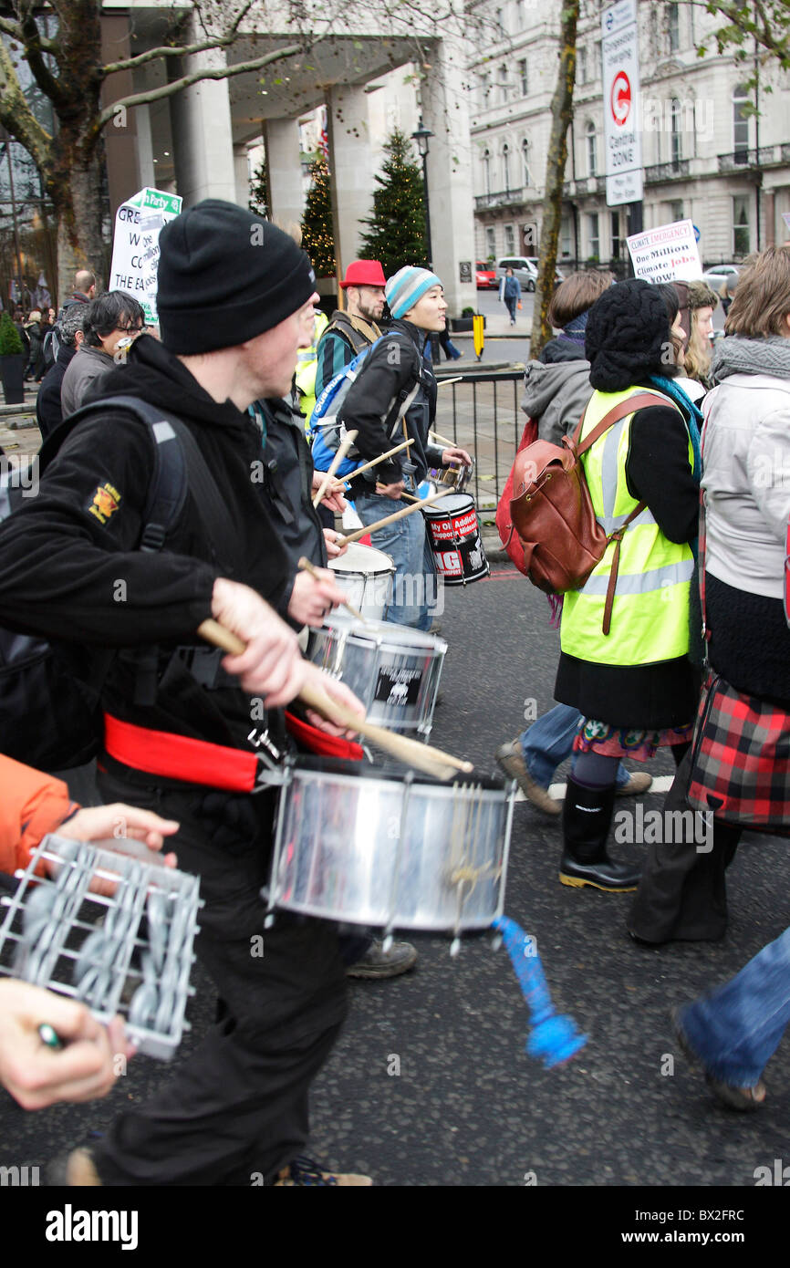 Climate change protesters beating drums in London Stock Photo - Alamy