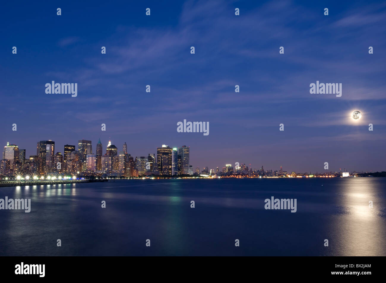 Manhattan skyline on a full moon night Stock Photo - Alamy