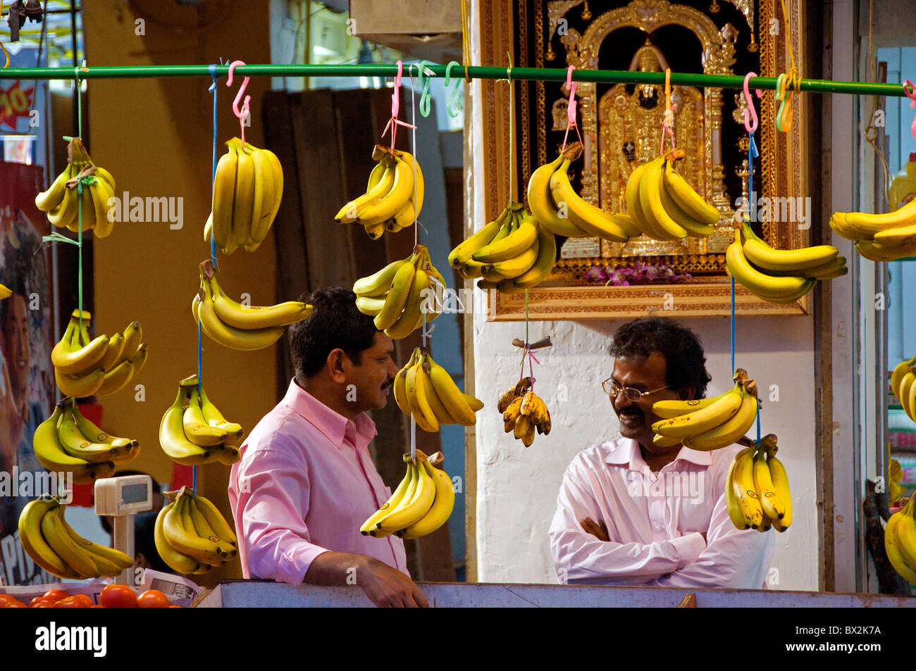 Two men standing at banana stand in singapore Stock Photo - Alamy