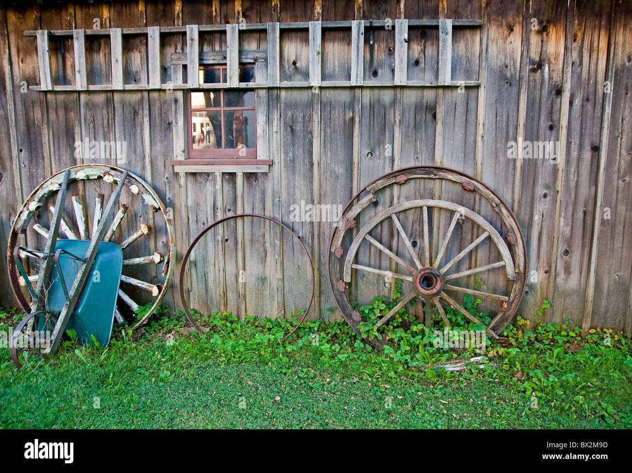 wall of old wooden barn window ladder wagon wheel wheels Stock Photo ...