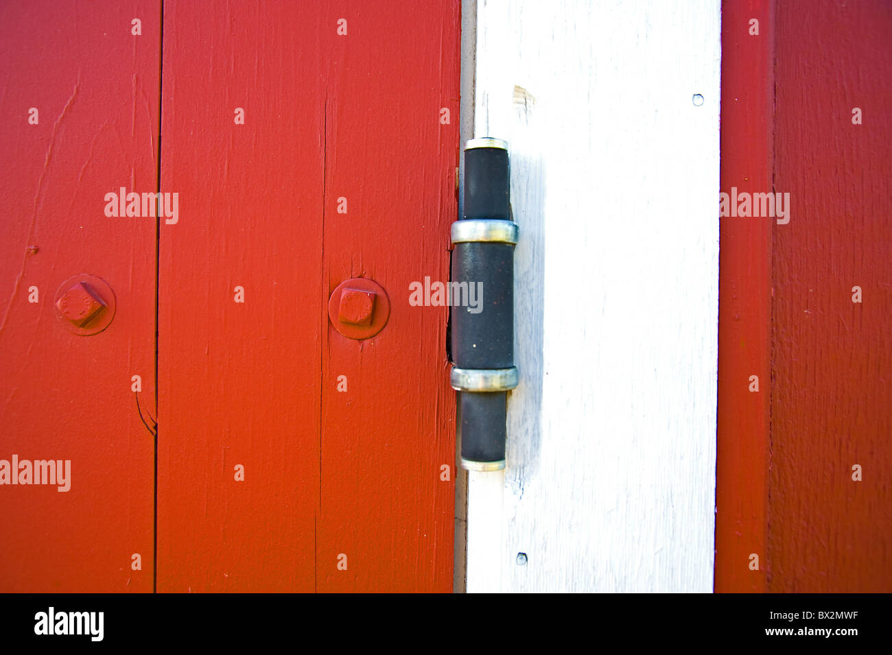 red door fragment hinge boards wood painted brown Stock Photo - Alamy