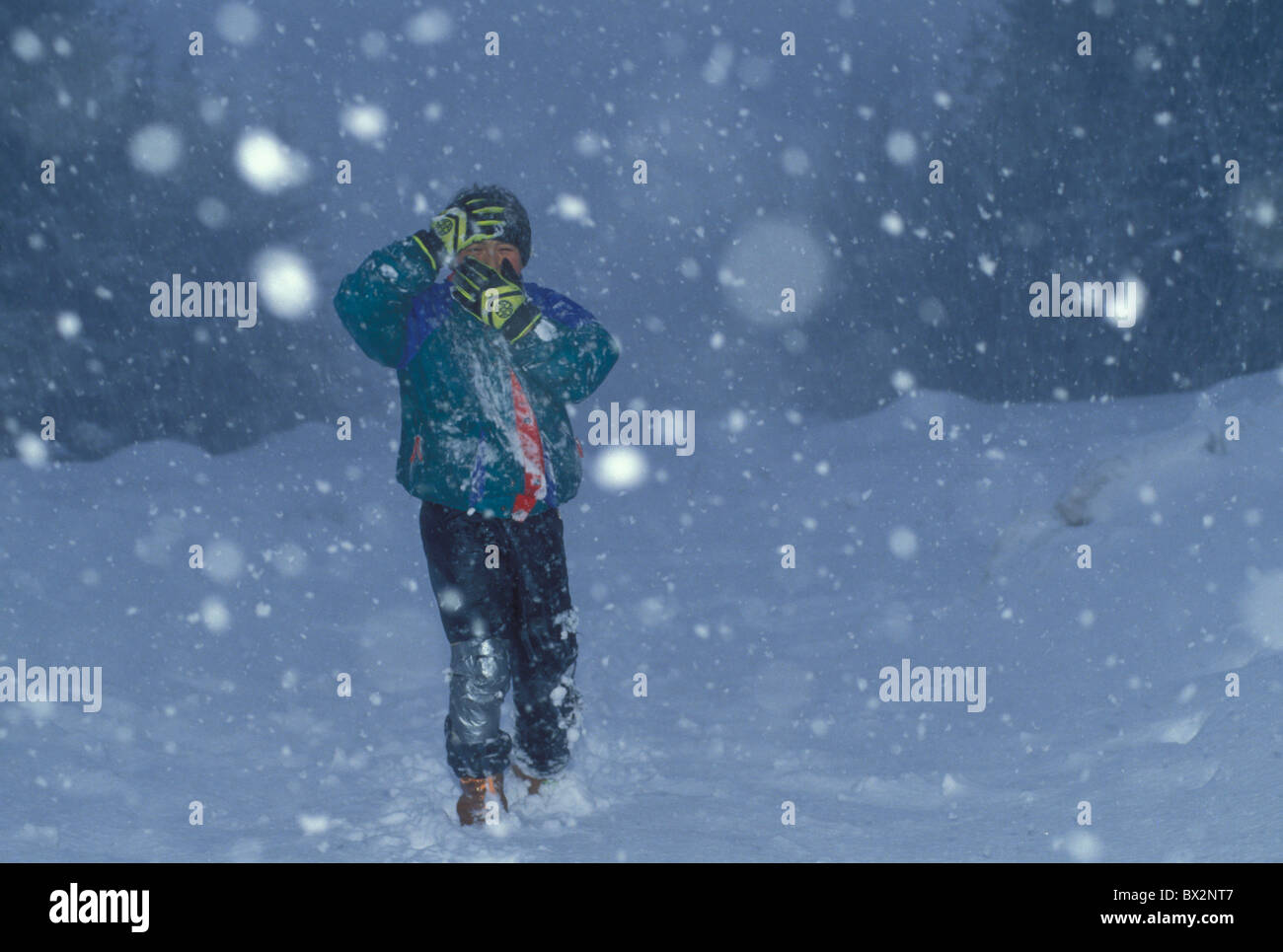 Alaska boy covering face hands Kenai peninsula snowstorm walking USA ...