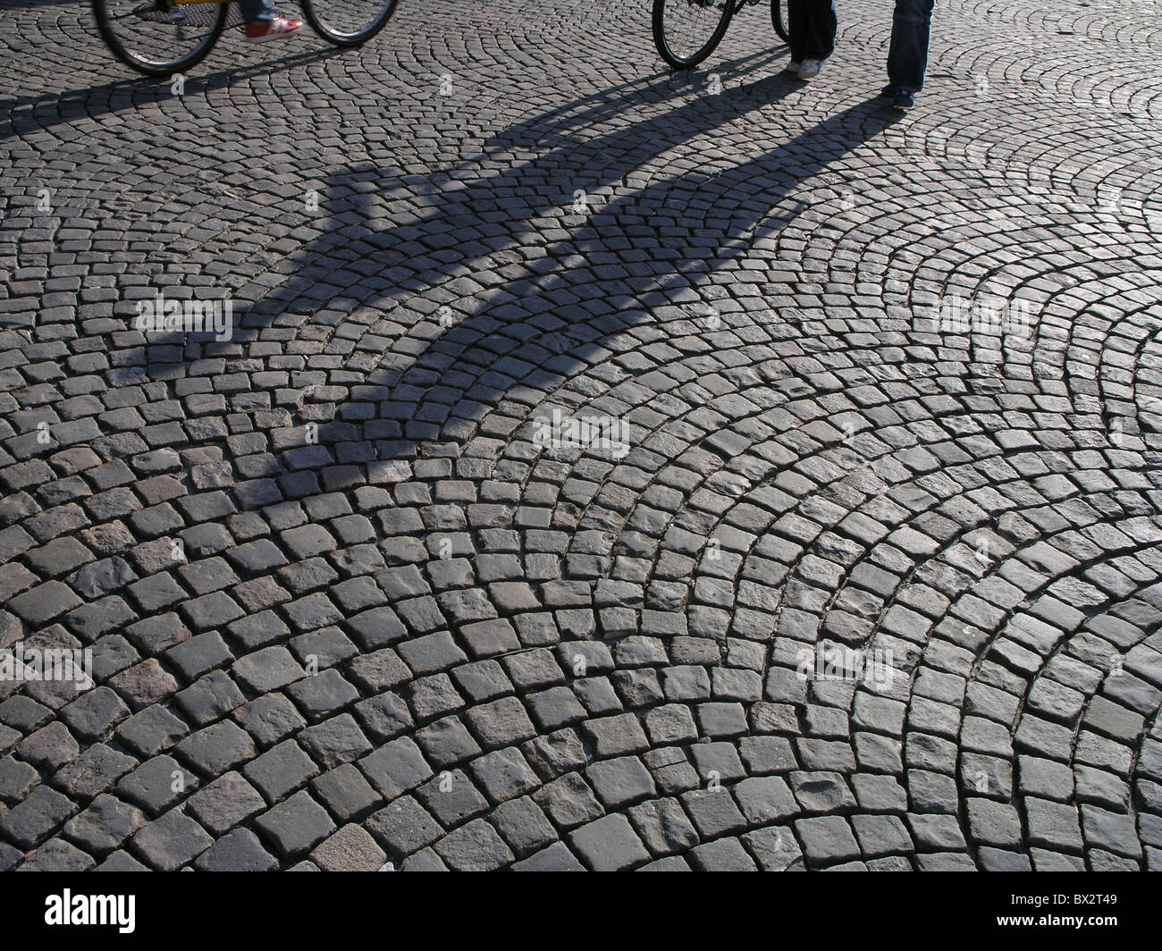bicycle bike Cobblestones legs passersby pavement paving stones place ...