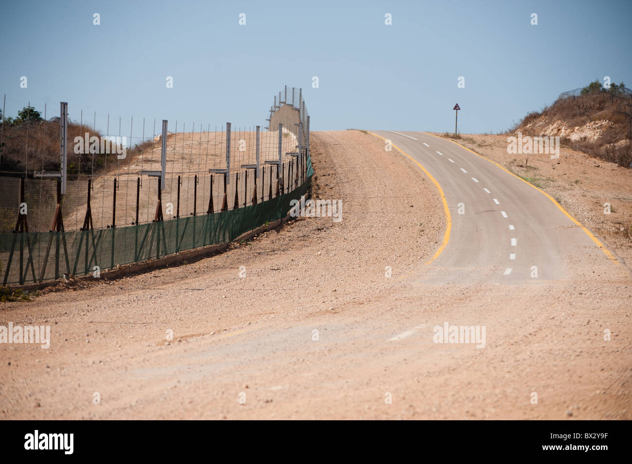 A section of the Israeli separation barrier--here, a fence with sensors ...