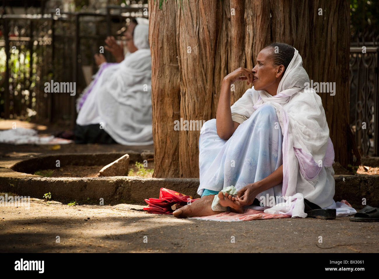 Woman relaxing and contemplating outside a church in Addis Ababa ...