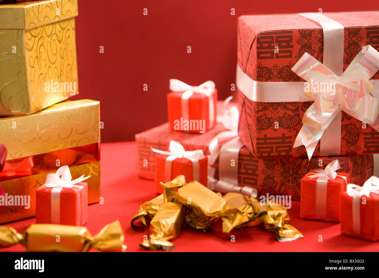 Close-up of many red giftboxes and sweets in golden wrapping Stock ...