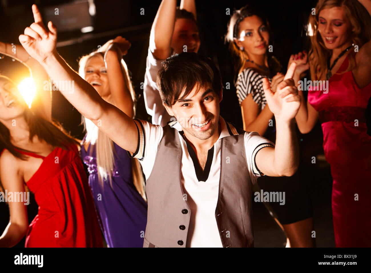 Portrait of energetic dancer on background of happy girls having fun ...