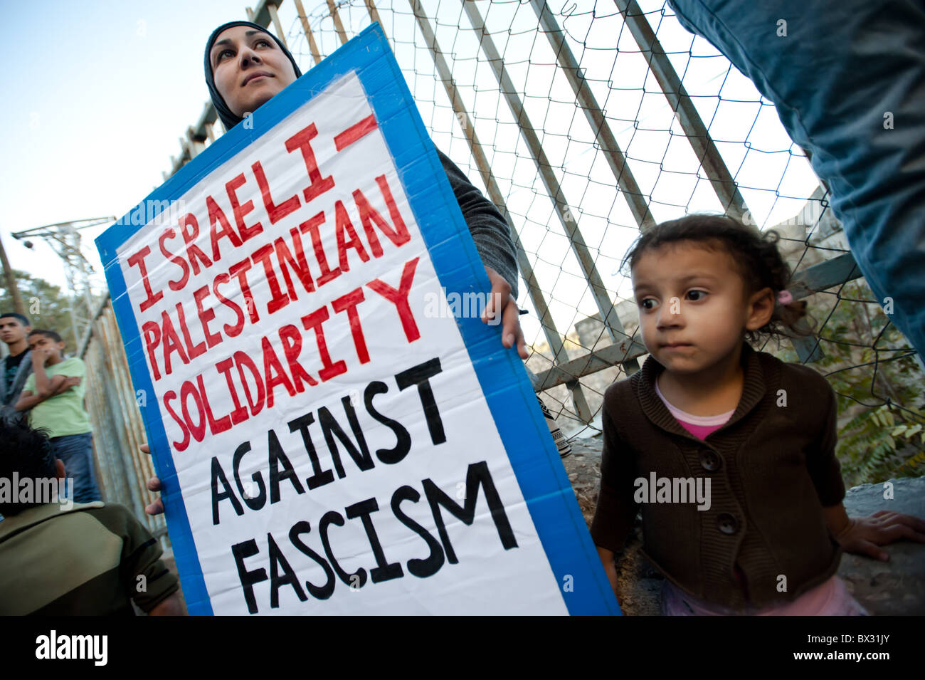 A woman marches in the Al-Issawiya neighborhood to protest the ...