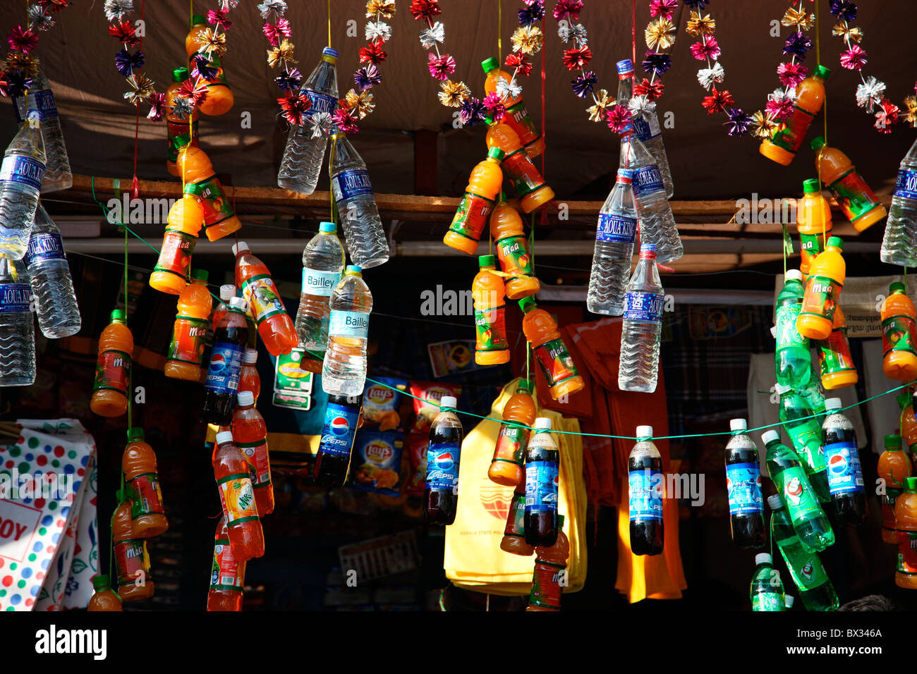 Refreshment bottles hanging in a grocery shop in india Stock Photo - Alamy