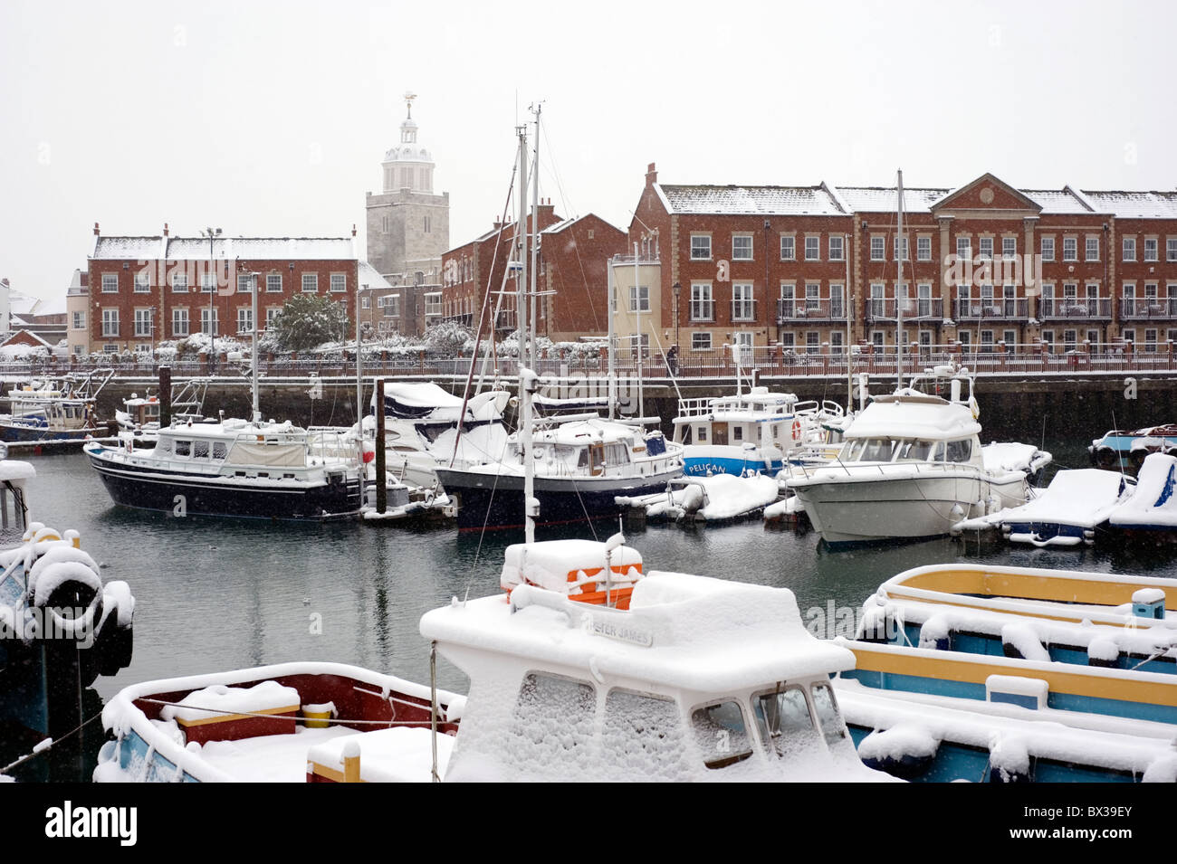 snow covered boats in harbour during a snow storm Stock Photo - Alamy