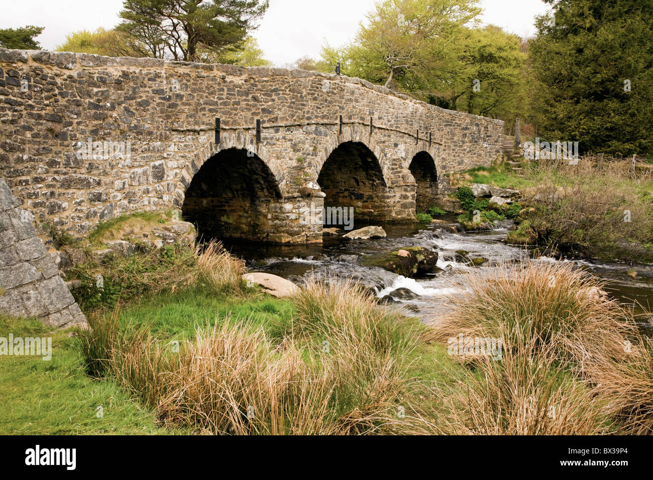 A Stone Bridge Going Over A River In Dartmoor National Park; Devon ...