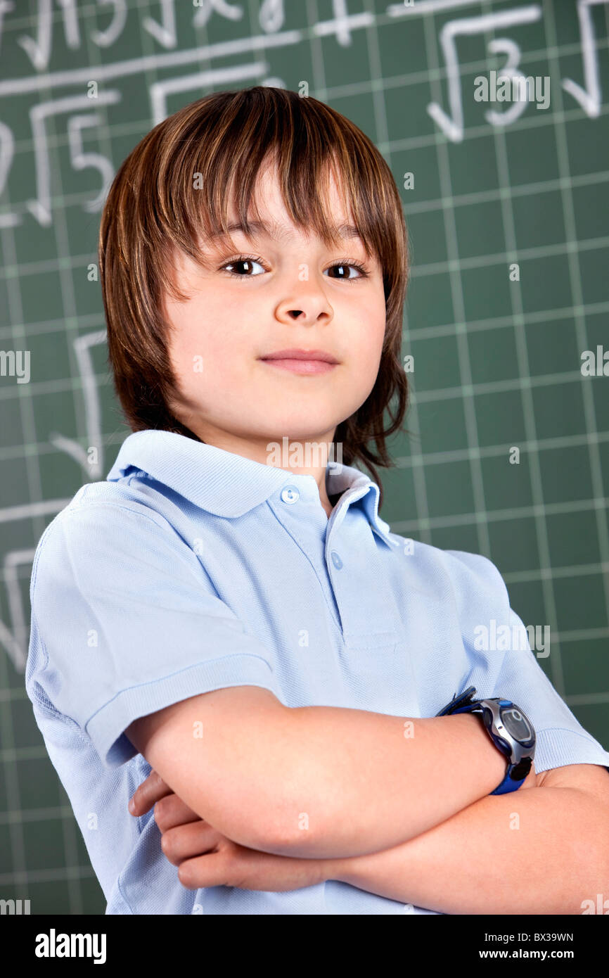 portrait of young boy in classroom in front of blackboard Stock Photo ...