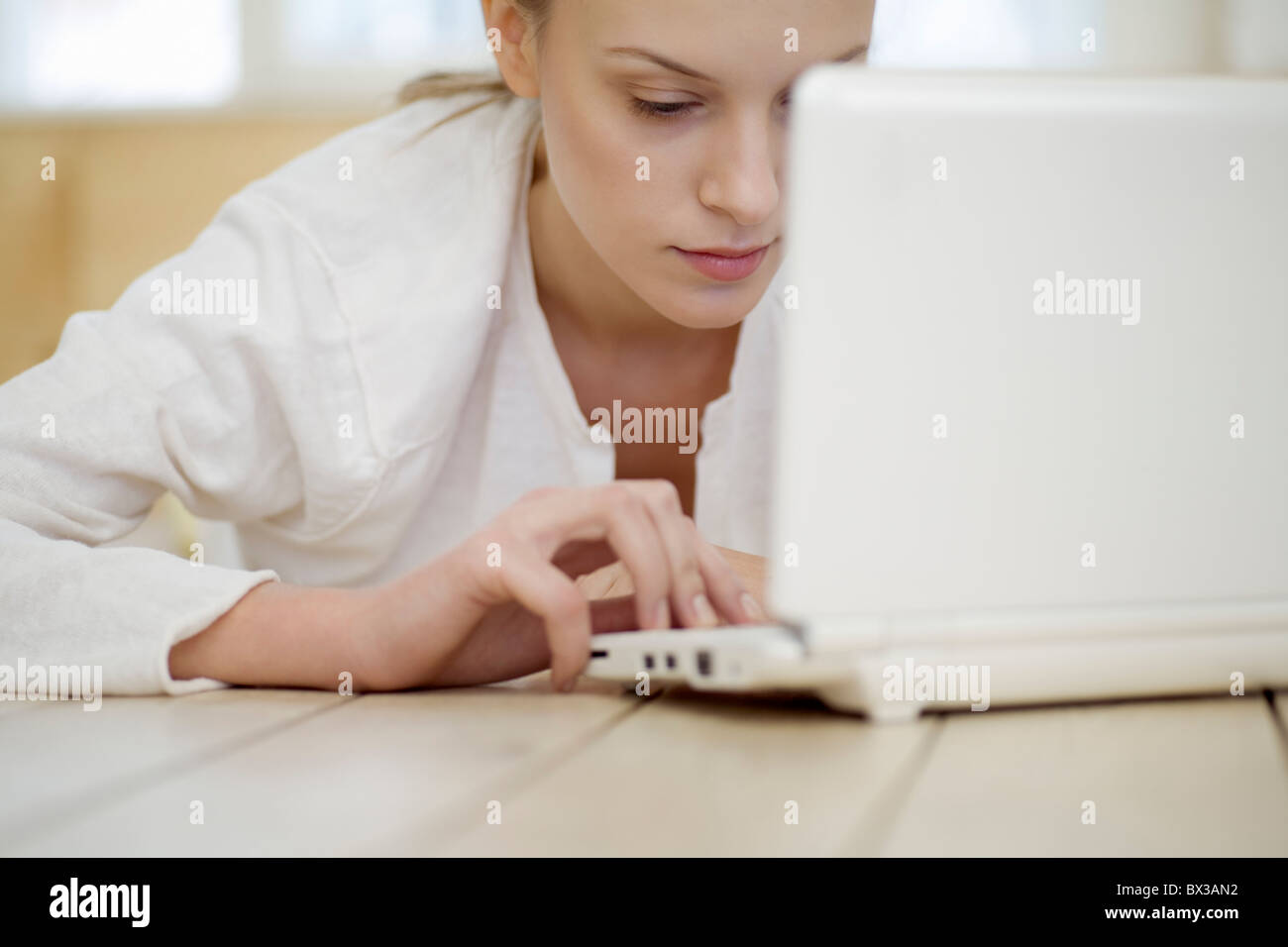 young woman lying on floor working with laptop computer Stock Photo - Alamy