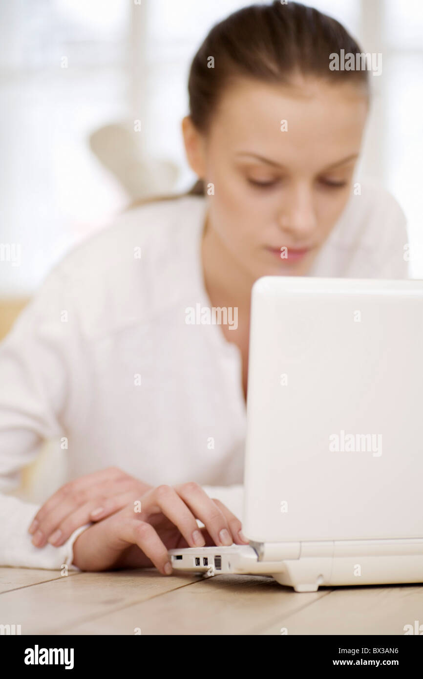 young woman lying on floor working with laptop computer Stock Photo - Alamy