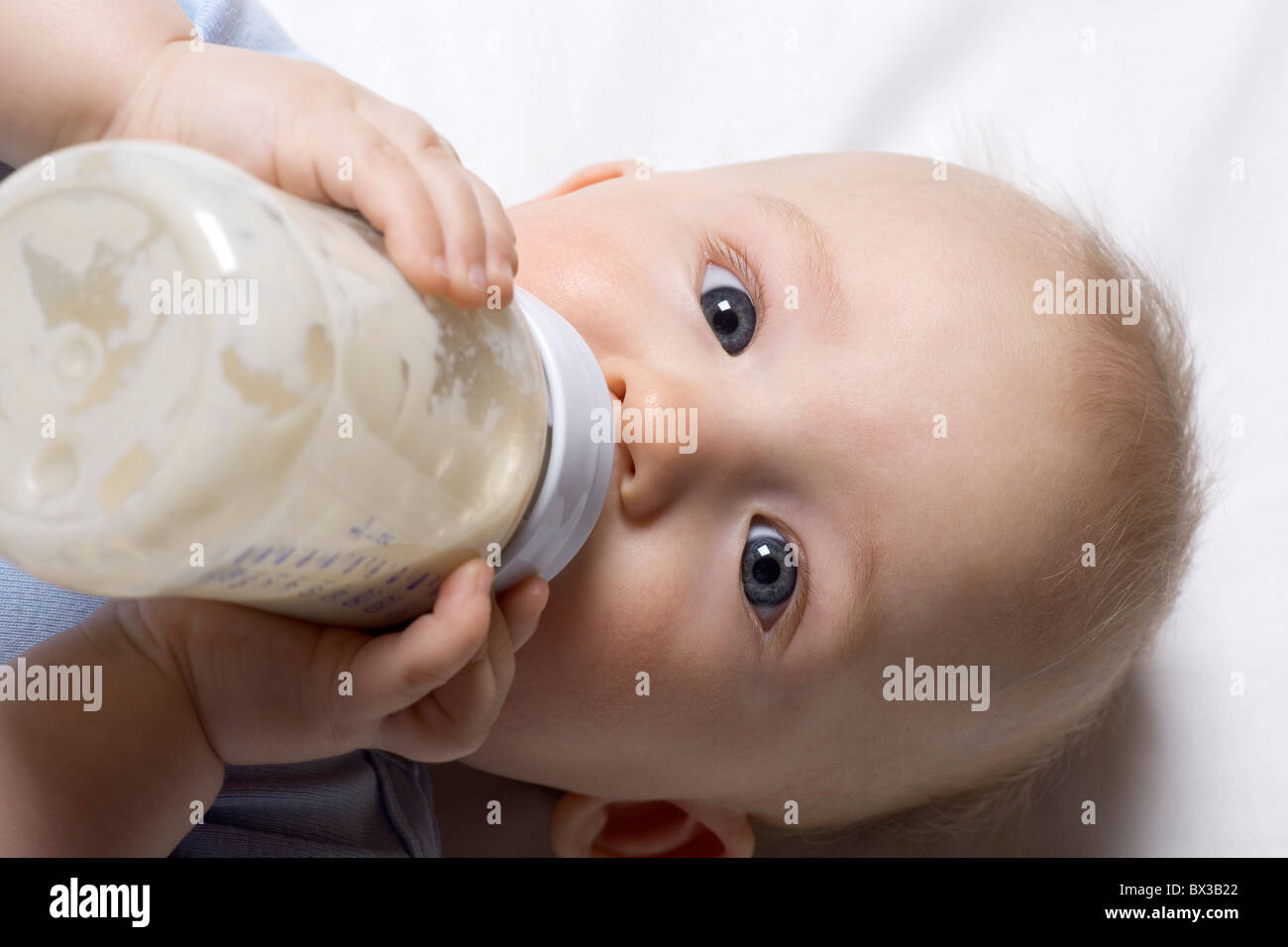 headshot of baby boy drinking from baby bottle Stock Photo - Alamy