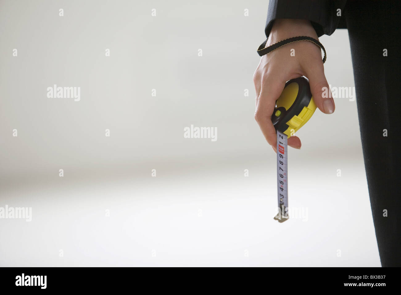 detail of young woman holding tape measure Stock Photo - Alamy
