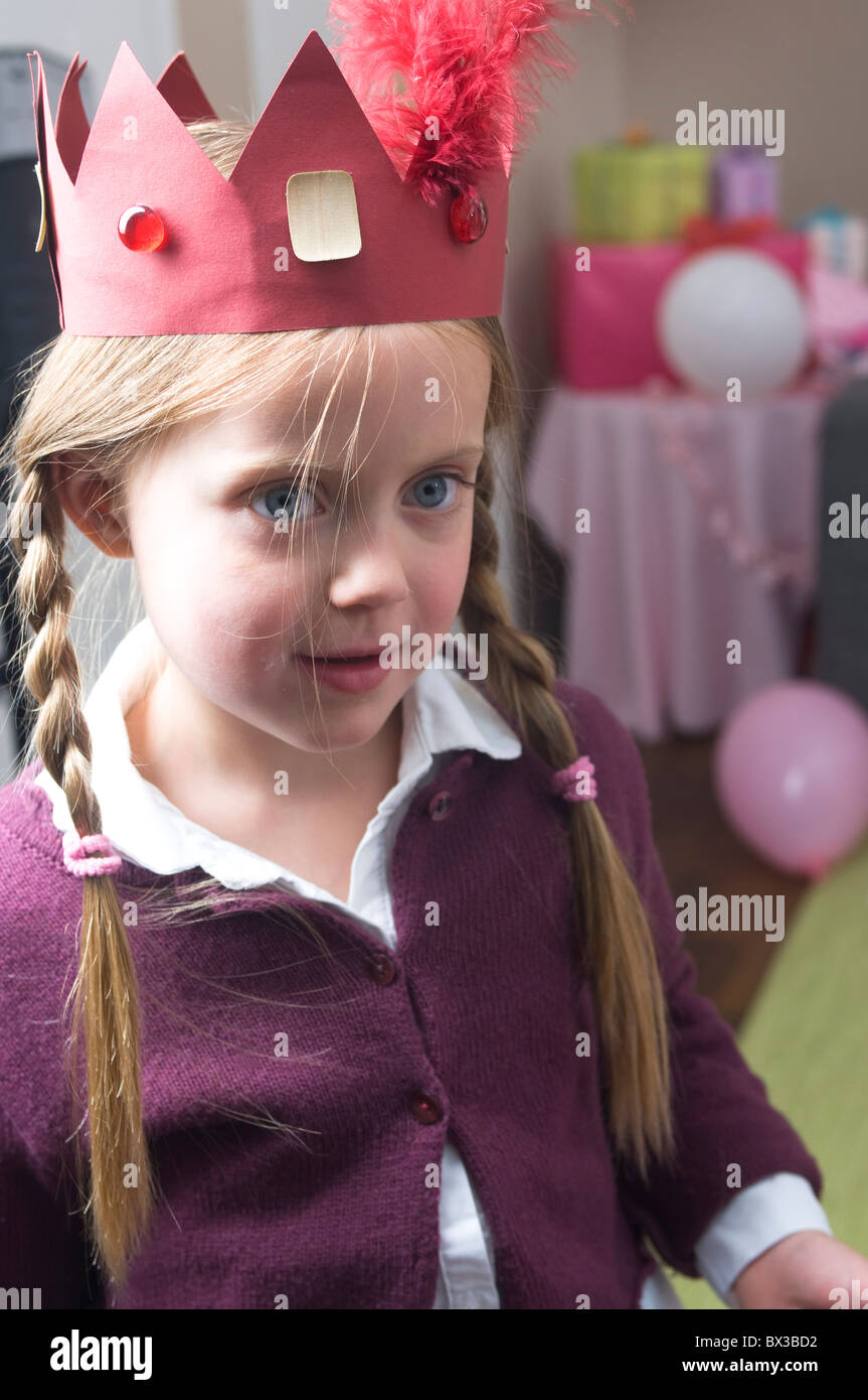 portrait of young girl wearing paper crown at birthday party Stock ...