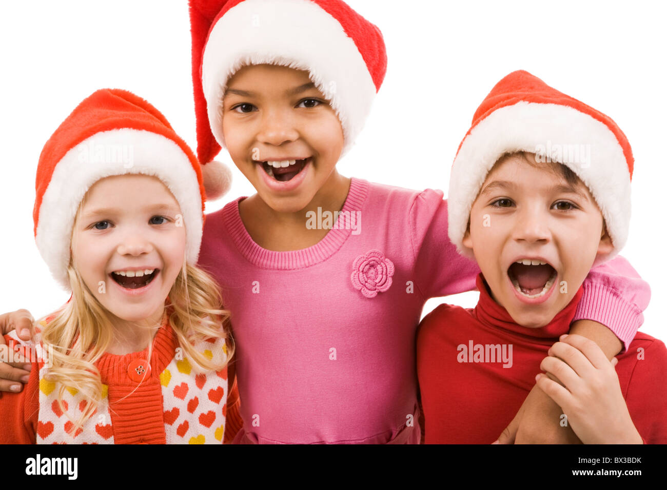 Photo of happy friends in Santa caps laughing over white background ...