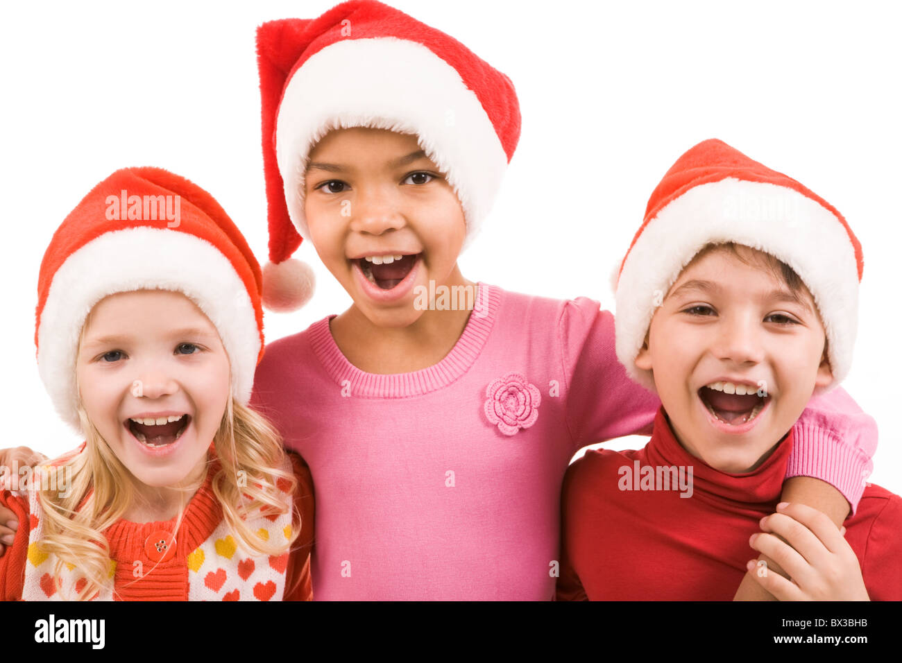 Photo of happy friends in Santa caps laughing over white background ...