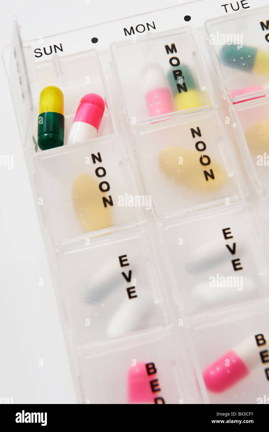 Different types of pills in a weekly dosage container Stock Photo - Alamy