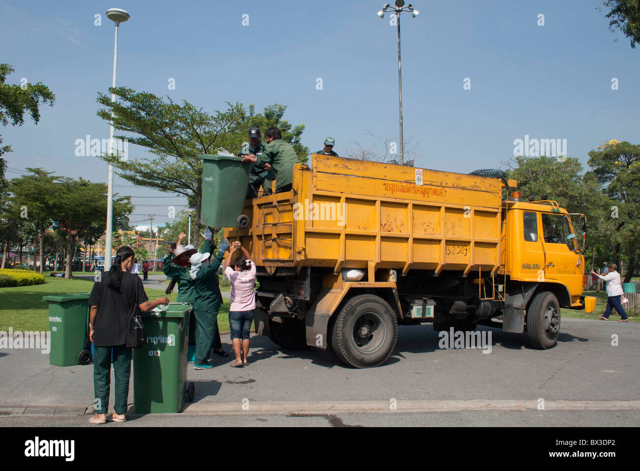 People loading garbages into the Truck Stock Photo - Alamy