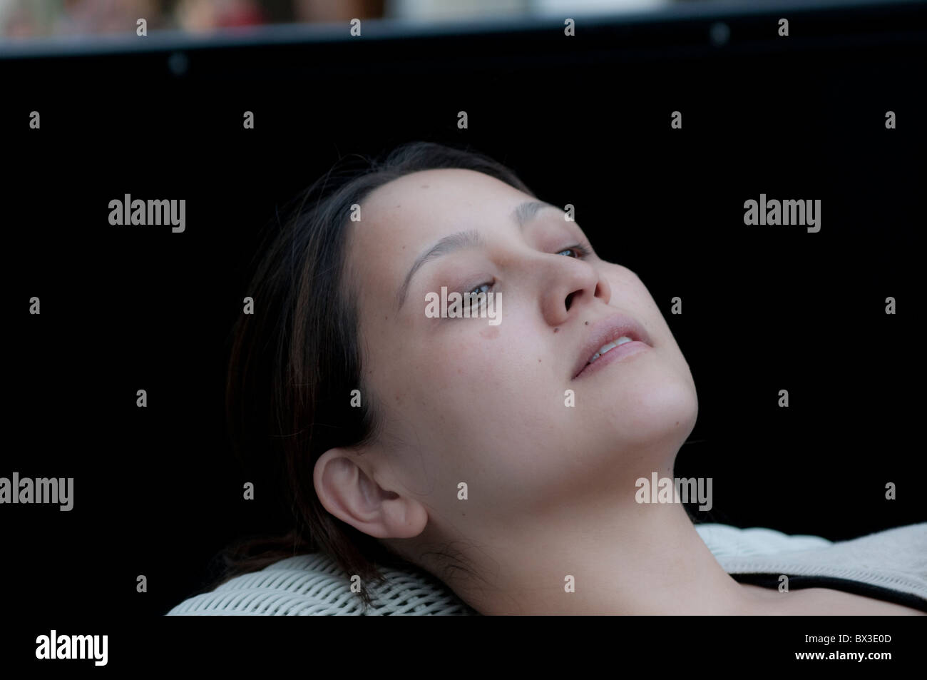 Young woman reclining Stock Photo - Alamy