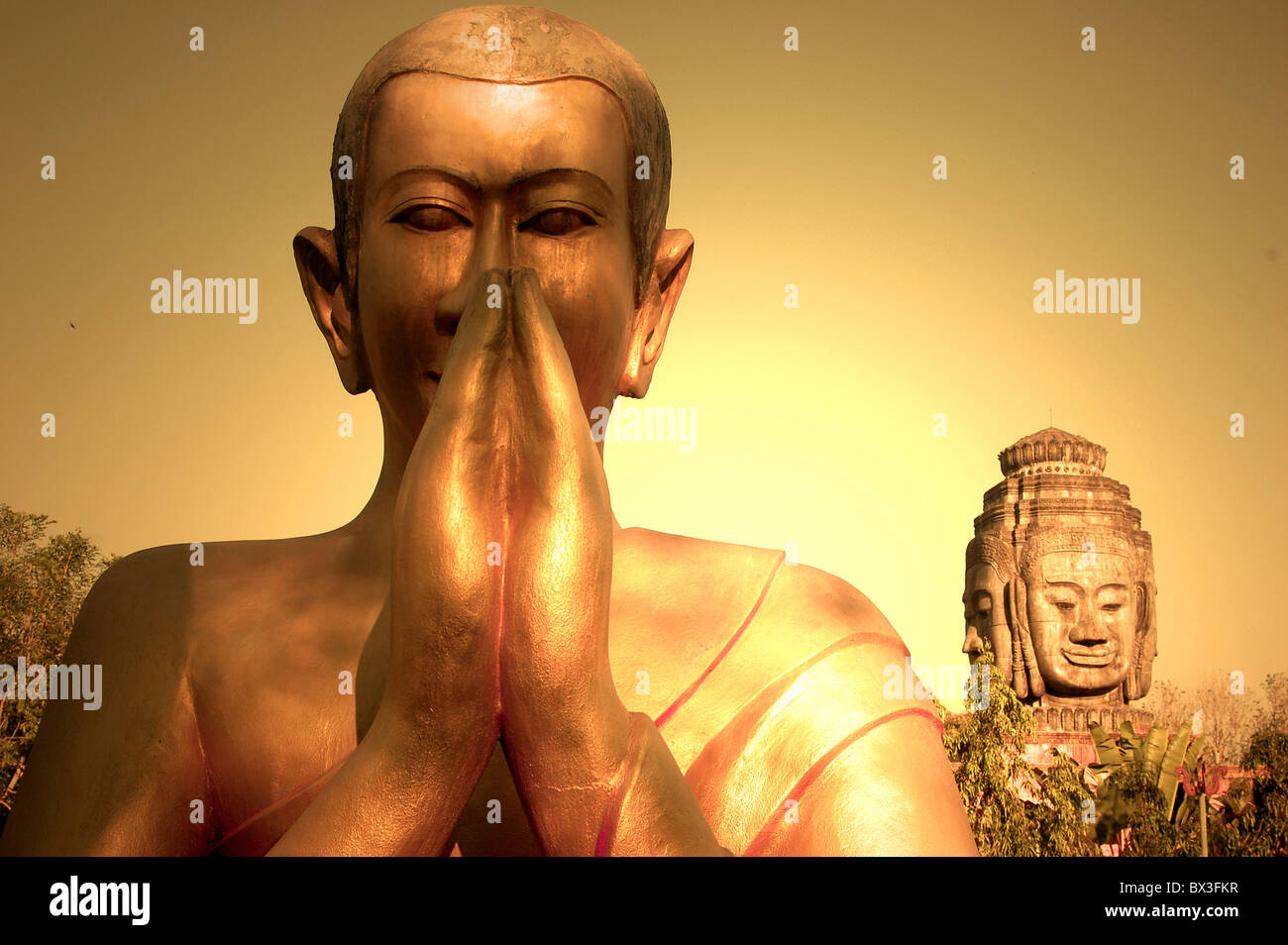 Golden statue of Buddha joining both hands Stock Photo - Alamy